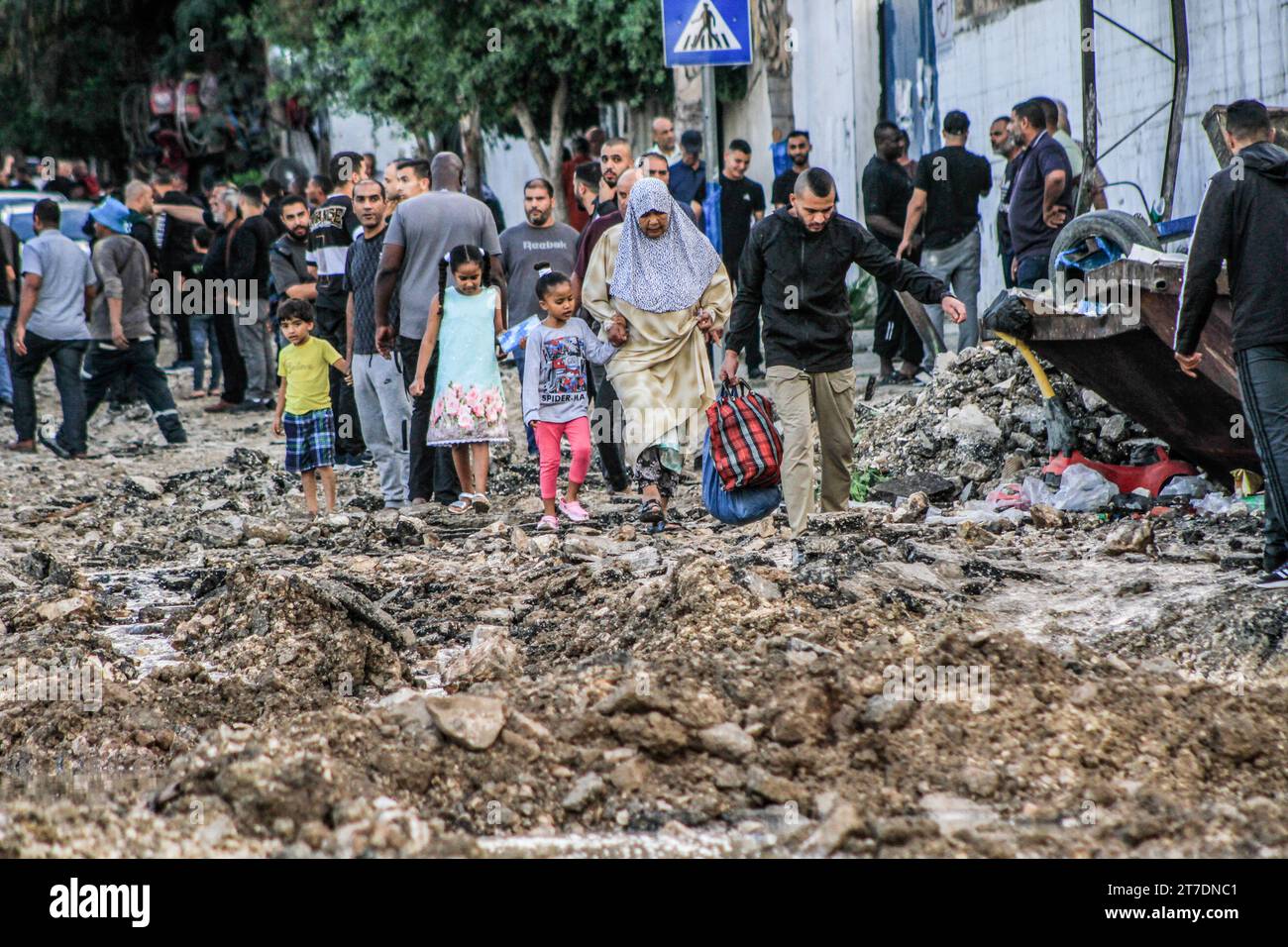 Tulkarm, Palestine. 14th Nov, 2023. Palestinians stand by a road ...