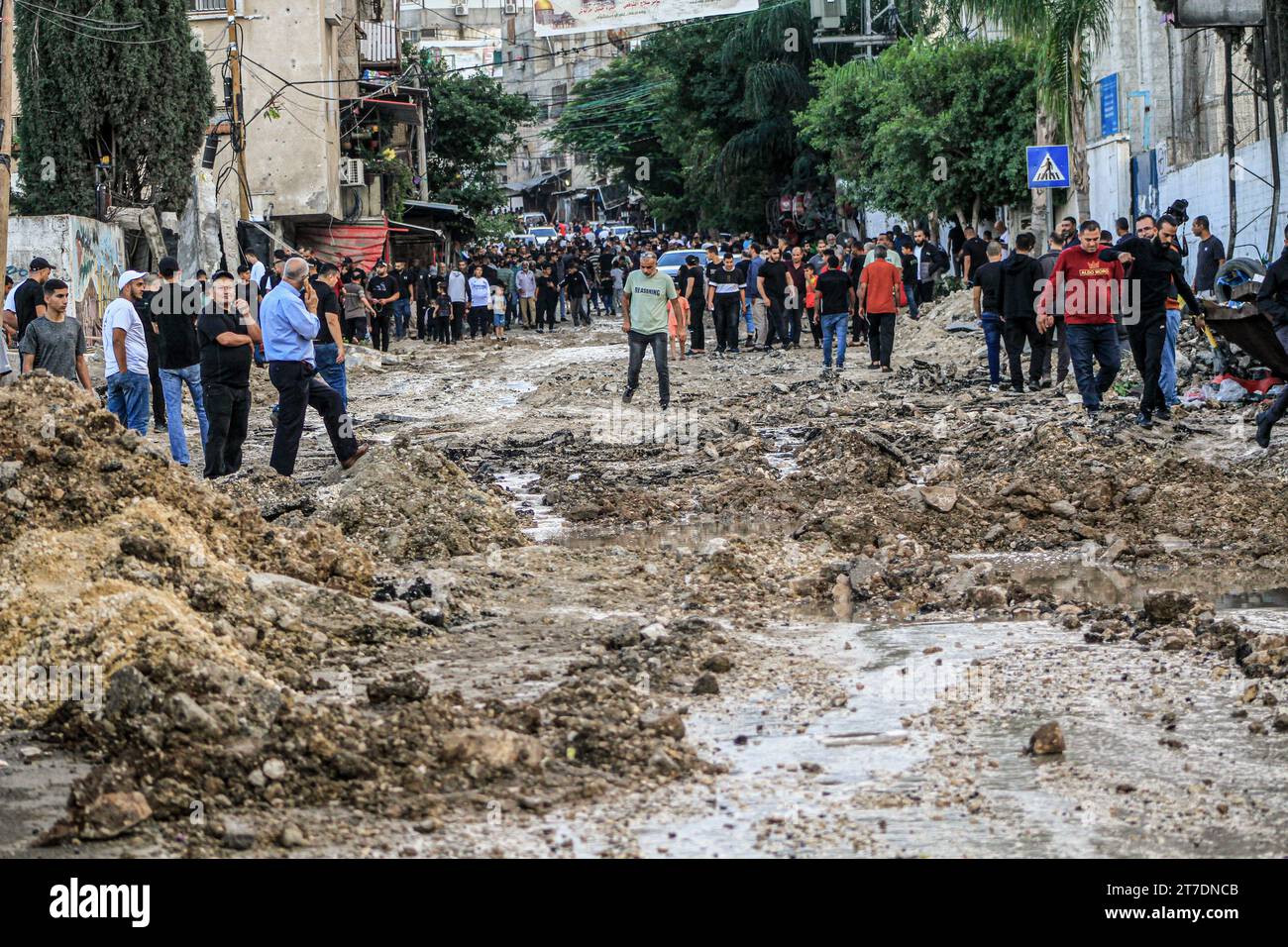 Tulkarm, Palestine. 14th Nov, 2023. Palestinians stand by a road ...