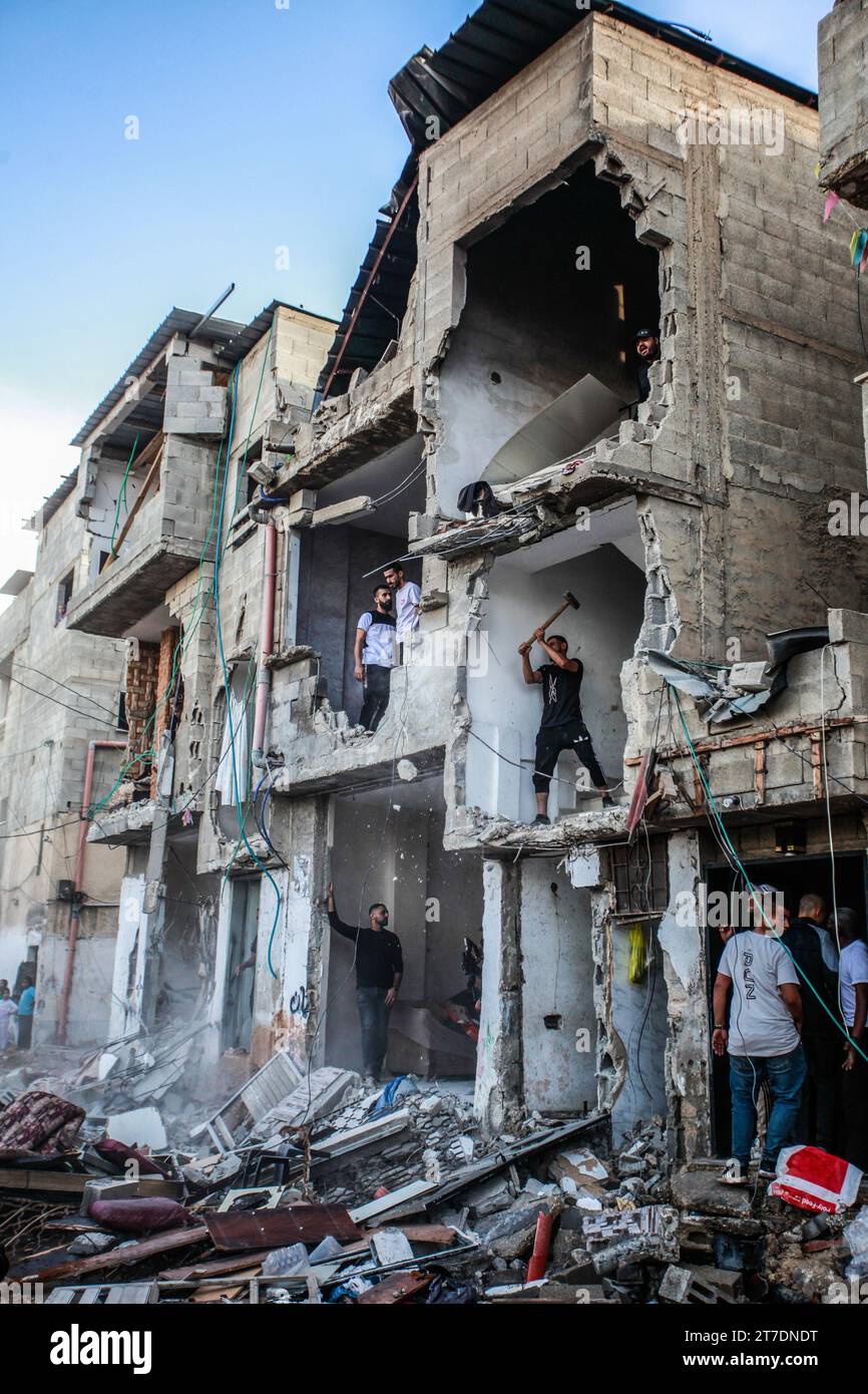Tulkarm, Palestine. 14th Nov, 2023. Palestinians inspect a damaged ...