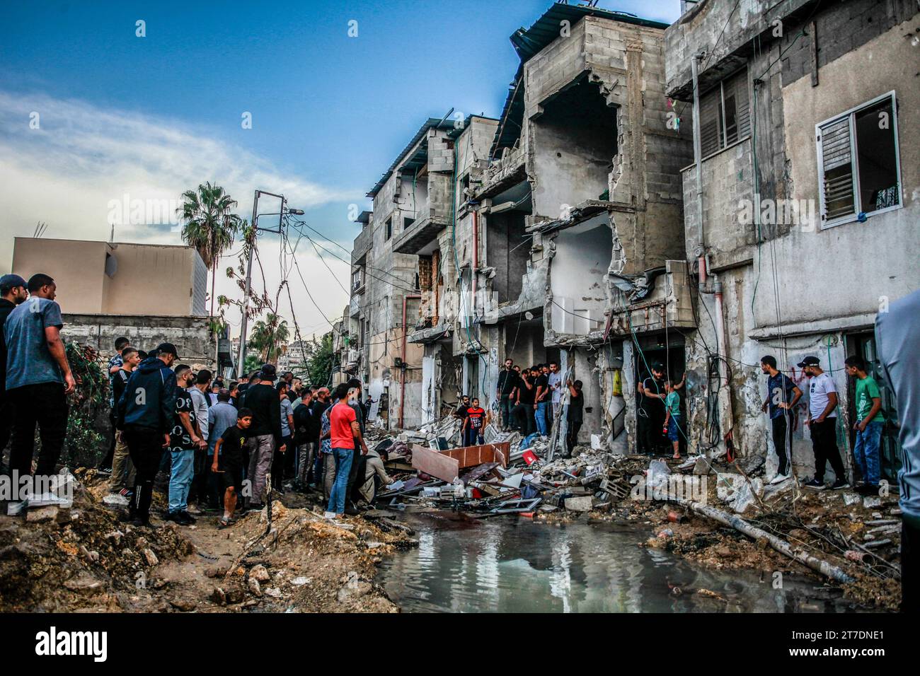 Tulkarm, Palestine. 14th Nov, 2023. Palestinians inspect a damaged ...