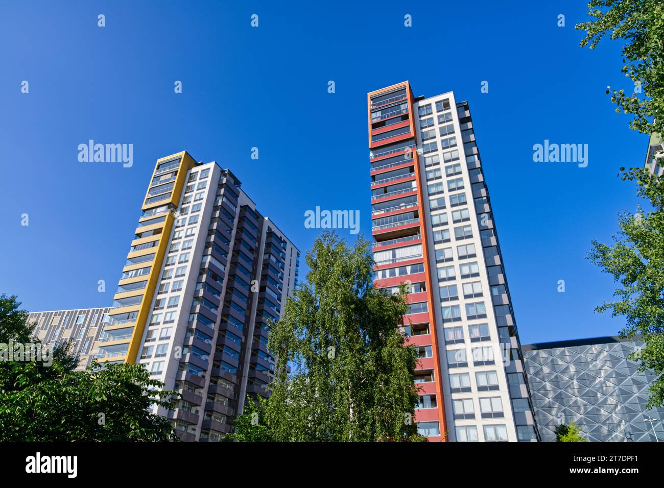 A scenic view of two towering skyscrapers overlooking a lush landscape ...