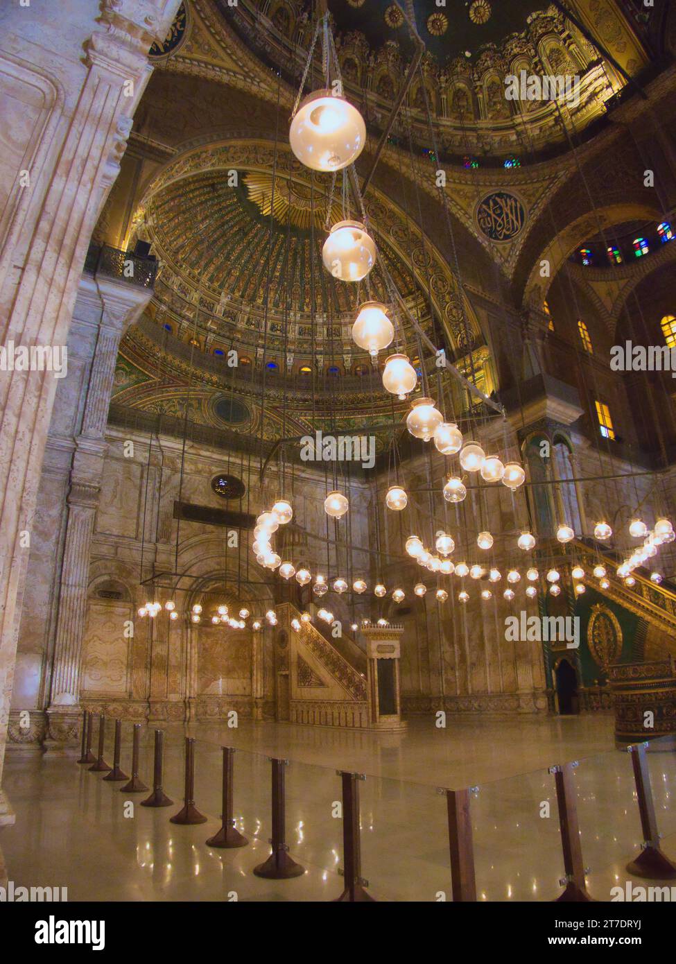An interior shot of a mosque with ornate light fixtures, providing a ...