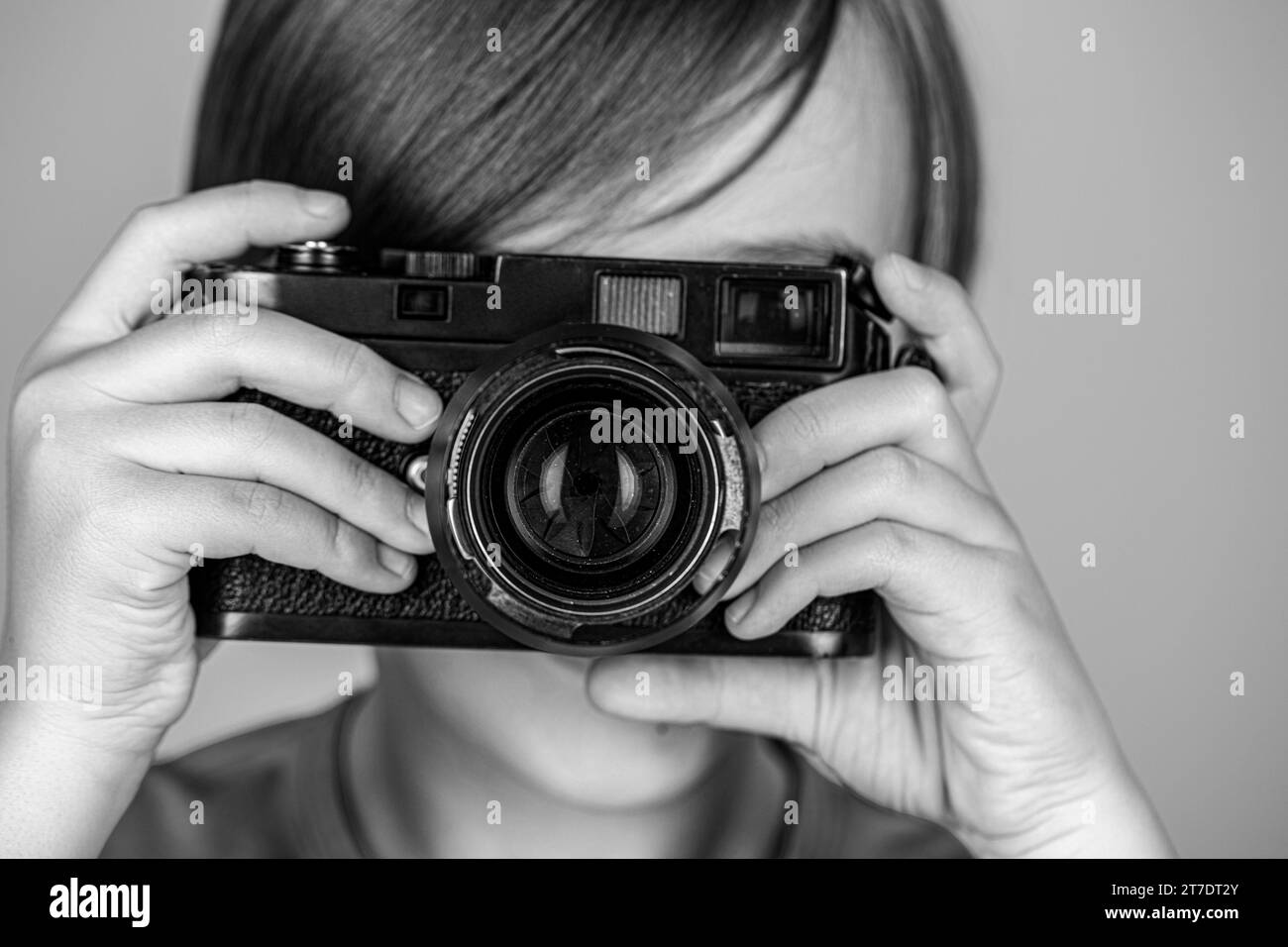 Child with camera. Cheerful smiling child holding a cameras. Little boy ...