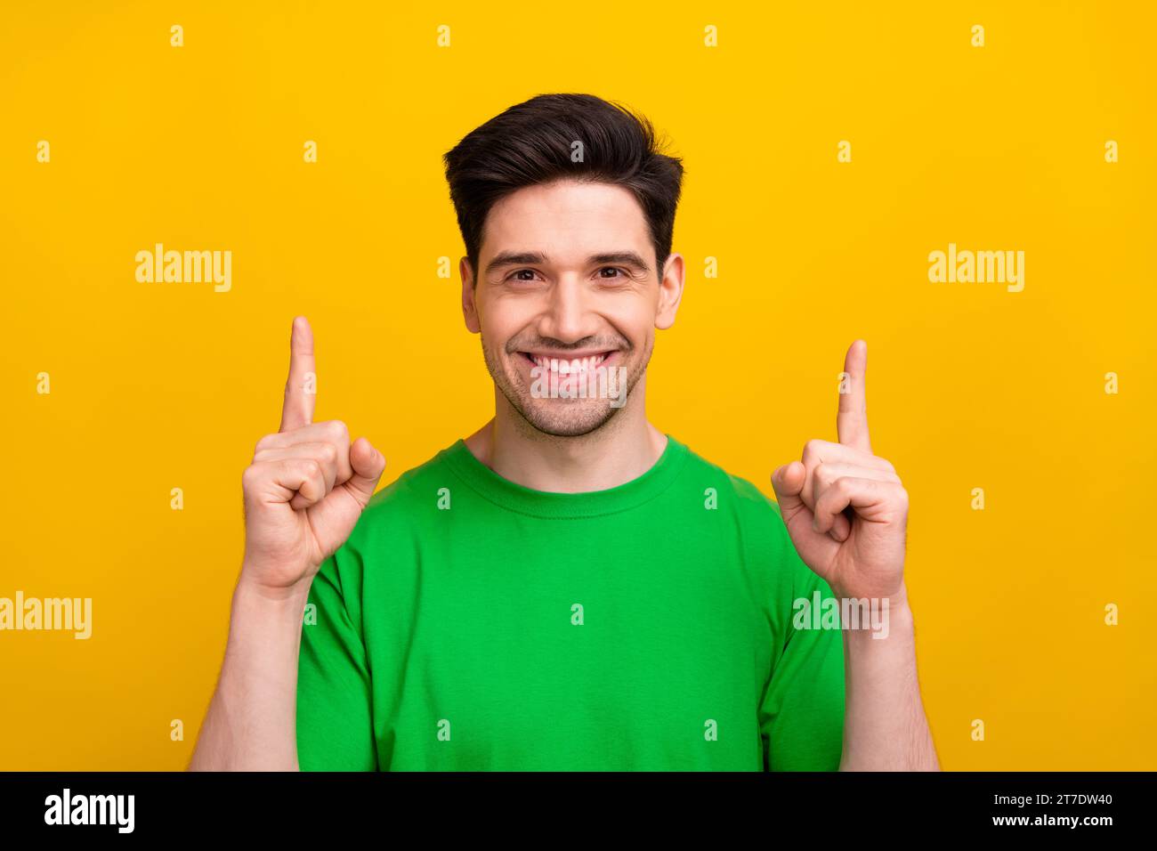Photo of handsome happy guy wear green t shirt direct fingers up ...