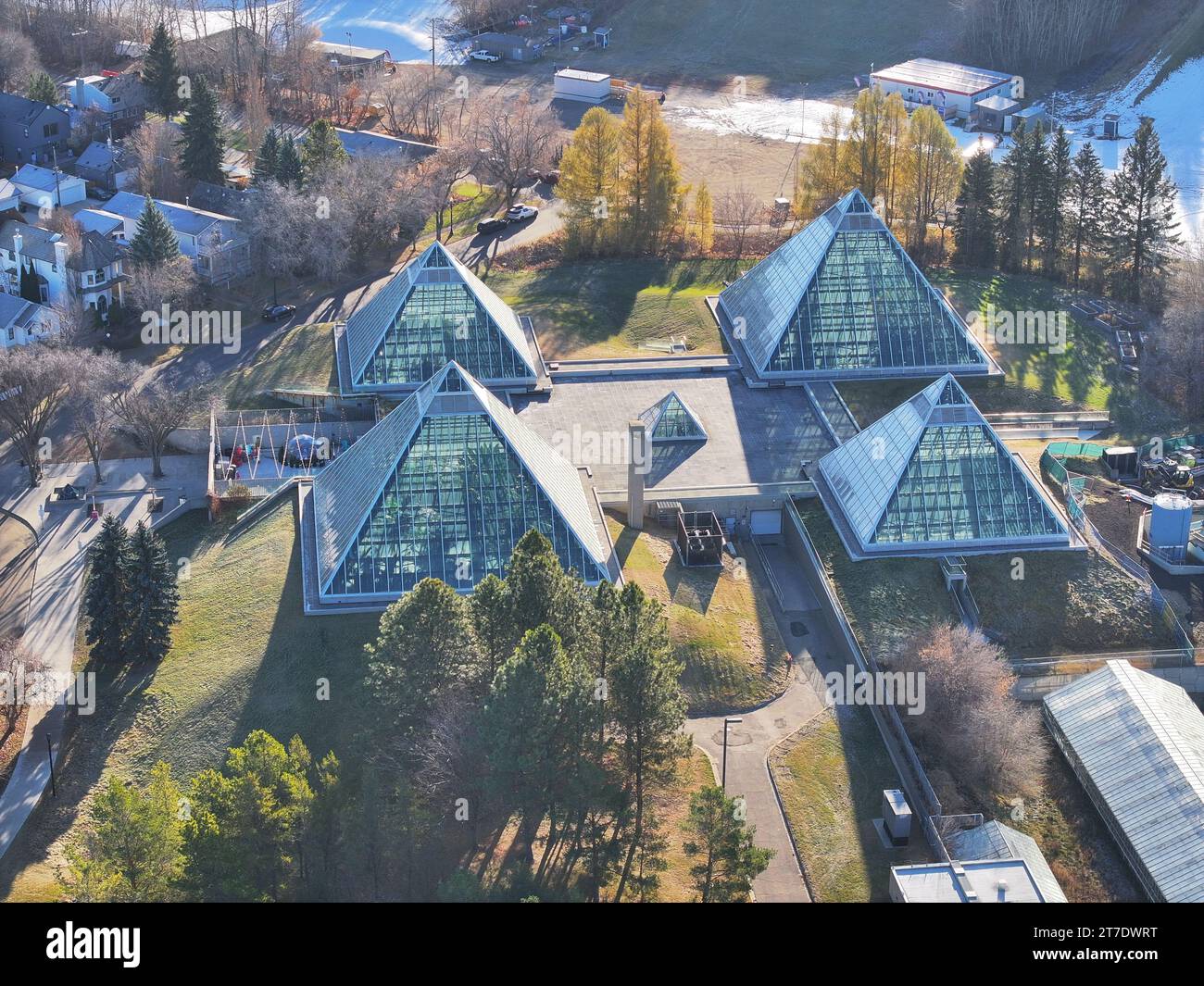 An aerial view of a modern building featuring three glass pyramids on ...