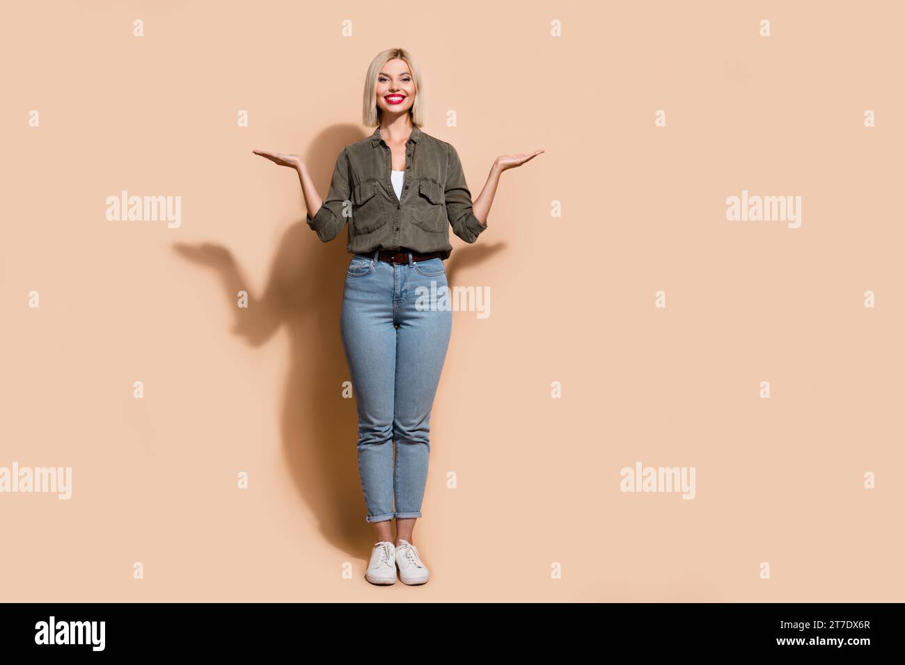 Full size photo of cheerful lady hold two open arms offer select pick ...