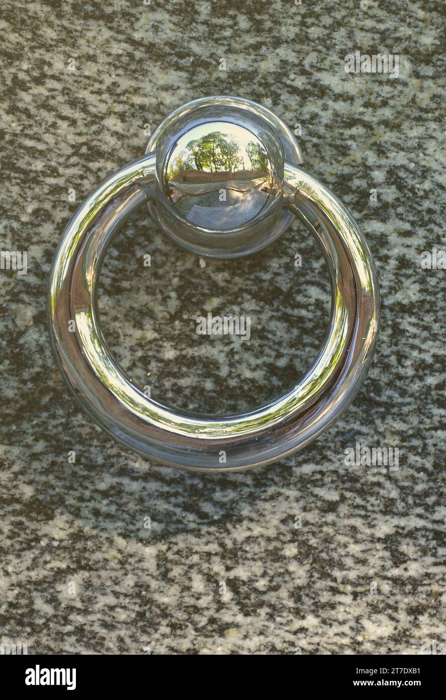 Metal ring on grave of cemetery. Rusty iron handle on granite tomb ...