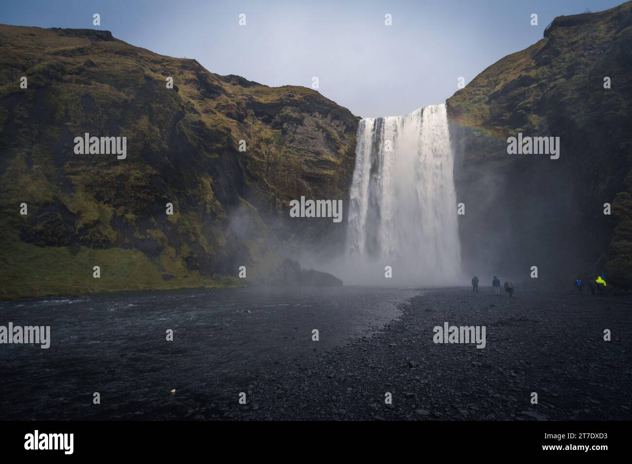 This image features a majestic waterfall with a high, powerful cascade ...