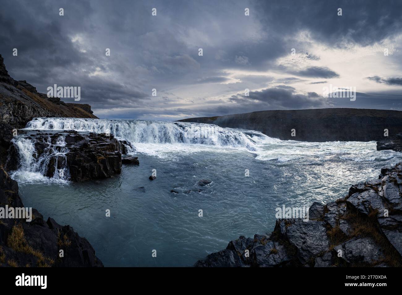 An idyllic scene featuring a magnificent waterfall cascading down a ...