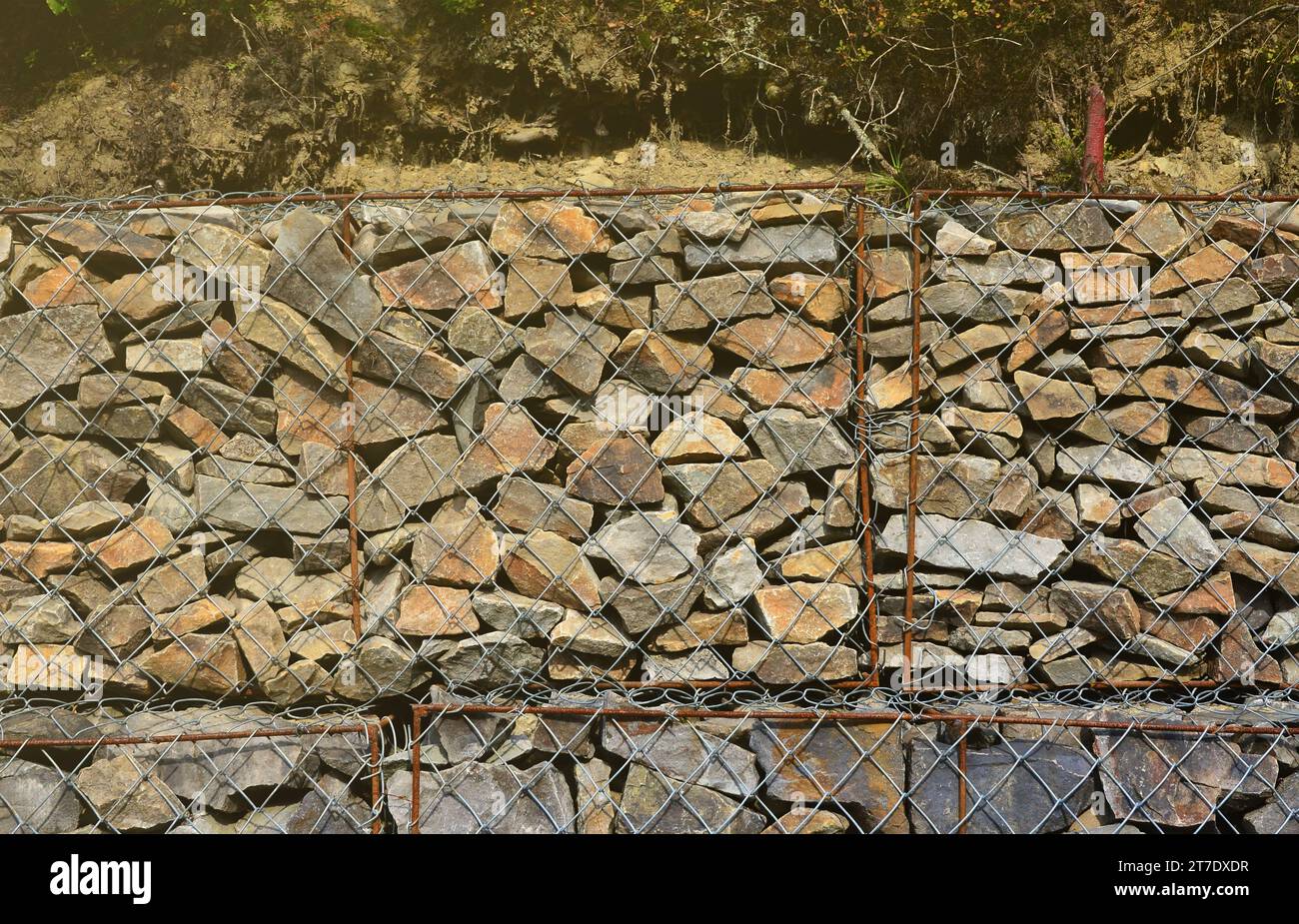 Photo of several gabions. The mesh cells of the cubic form are filled ...