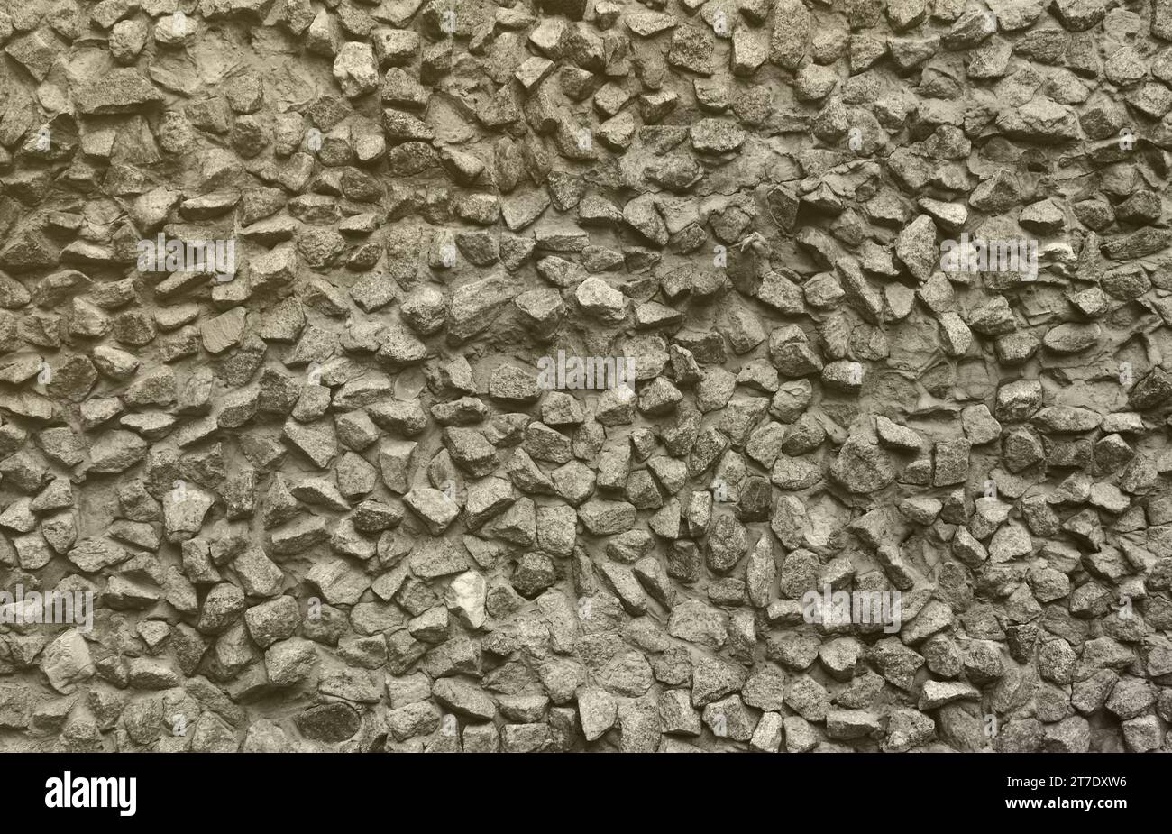 The texture of a strong stone wall of many concreted stones of various ...