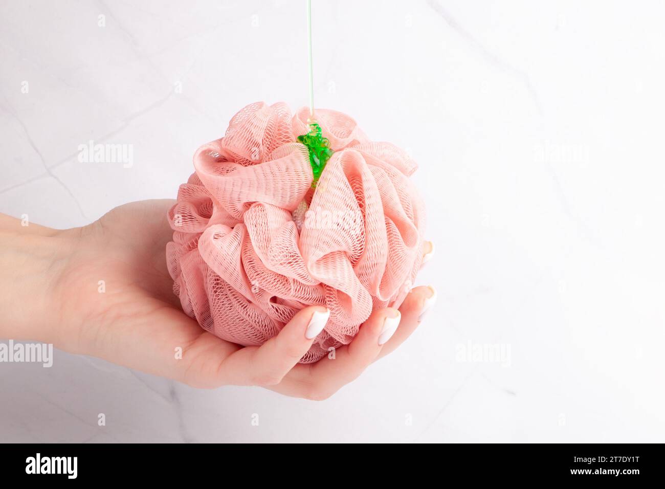 shampoo is flowing on the bath sponge in the female hand close up Stock ...