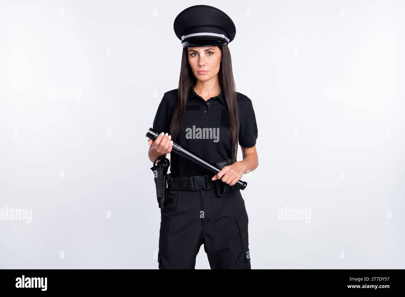 Photo of suspicious serious young police lady wear black uniform cap ...