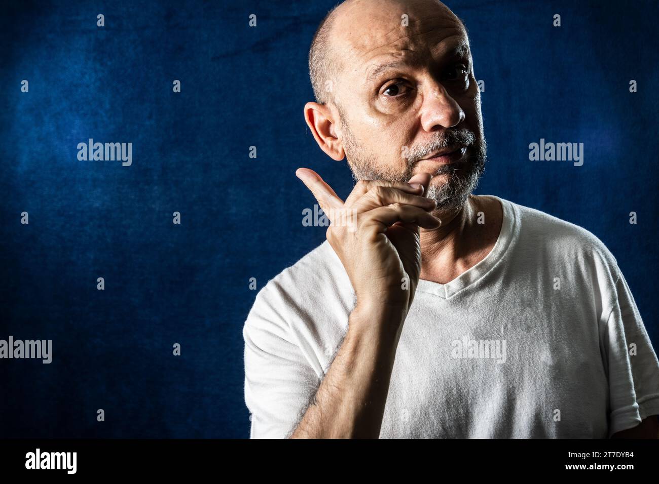 Man, confused, pointing to the side. Sad people. against blue ...