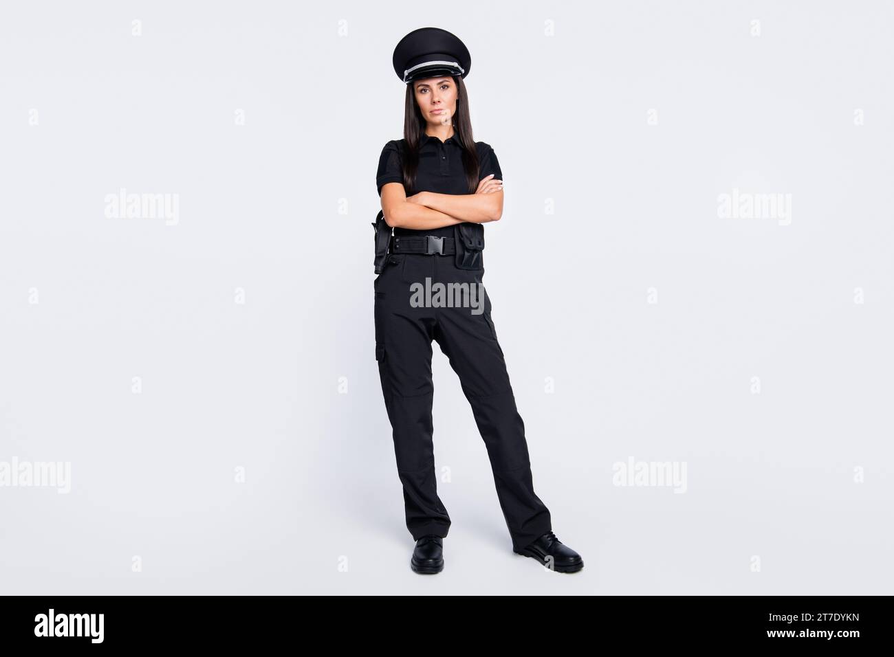 Photo of pretty serious young police lady wear black uniform cap arm ...