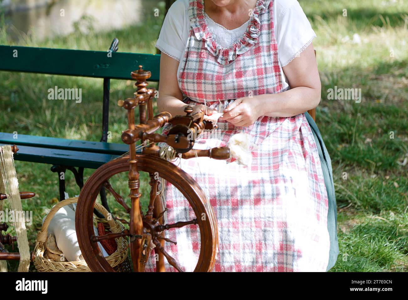 Young woman using a spinning wheel Stock Photo - Alamy