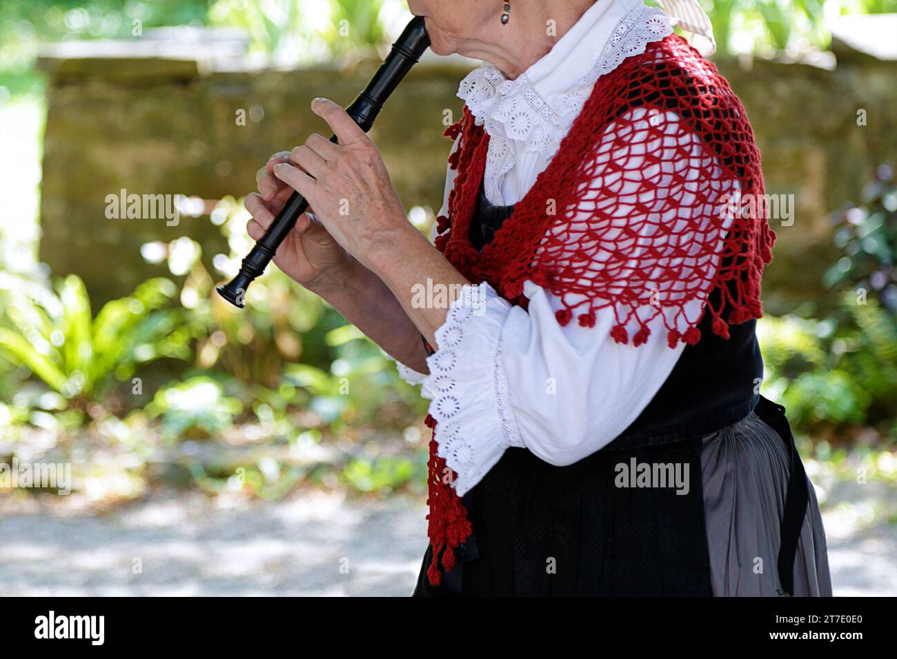 Senior woman playing the recorder in traditional clothes Stock Photo ...