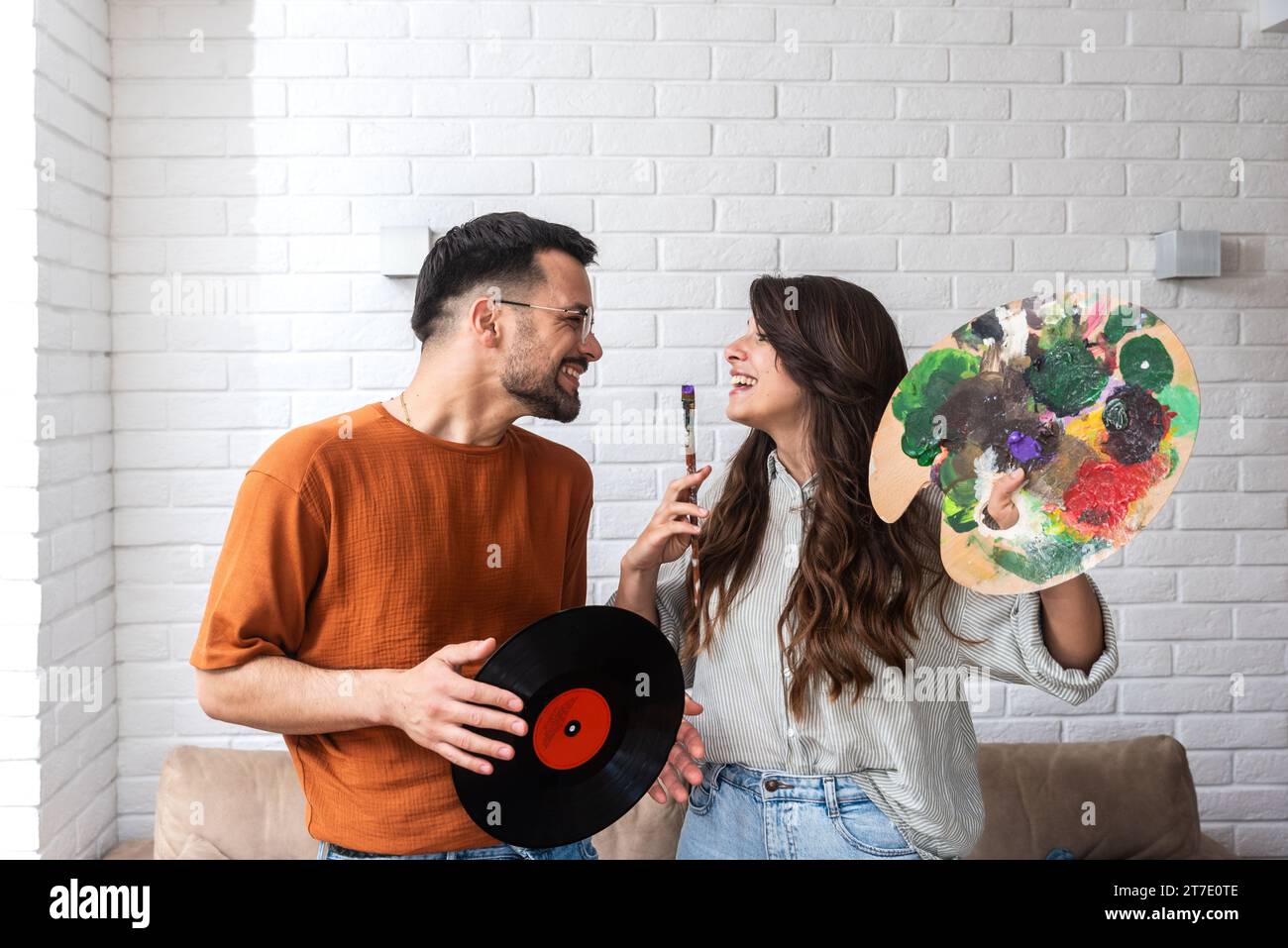 Young creative couple, artists musician and painter holding LP and ...