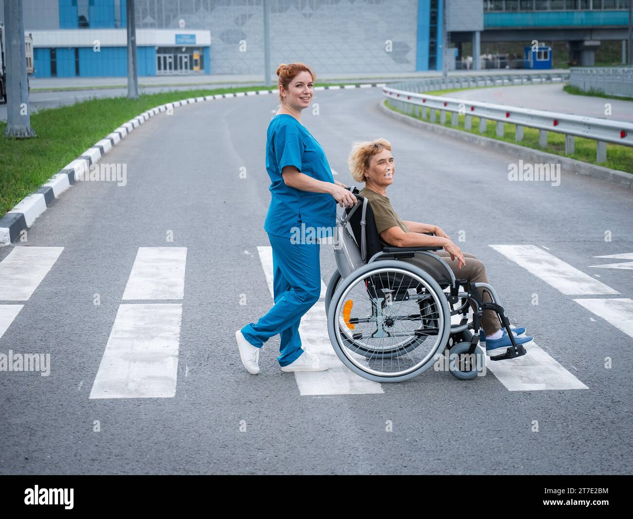 Helping elderly cross street hi-res stock photography and images - Alamy