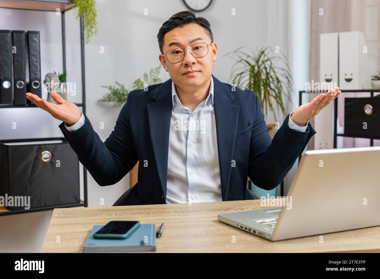 I don't know what to say. Confused business man working on laptop at ...