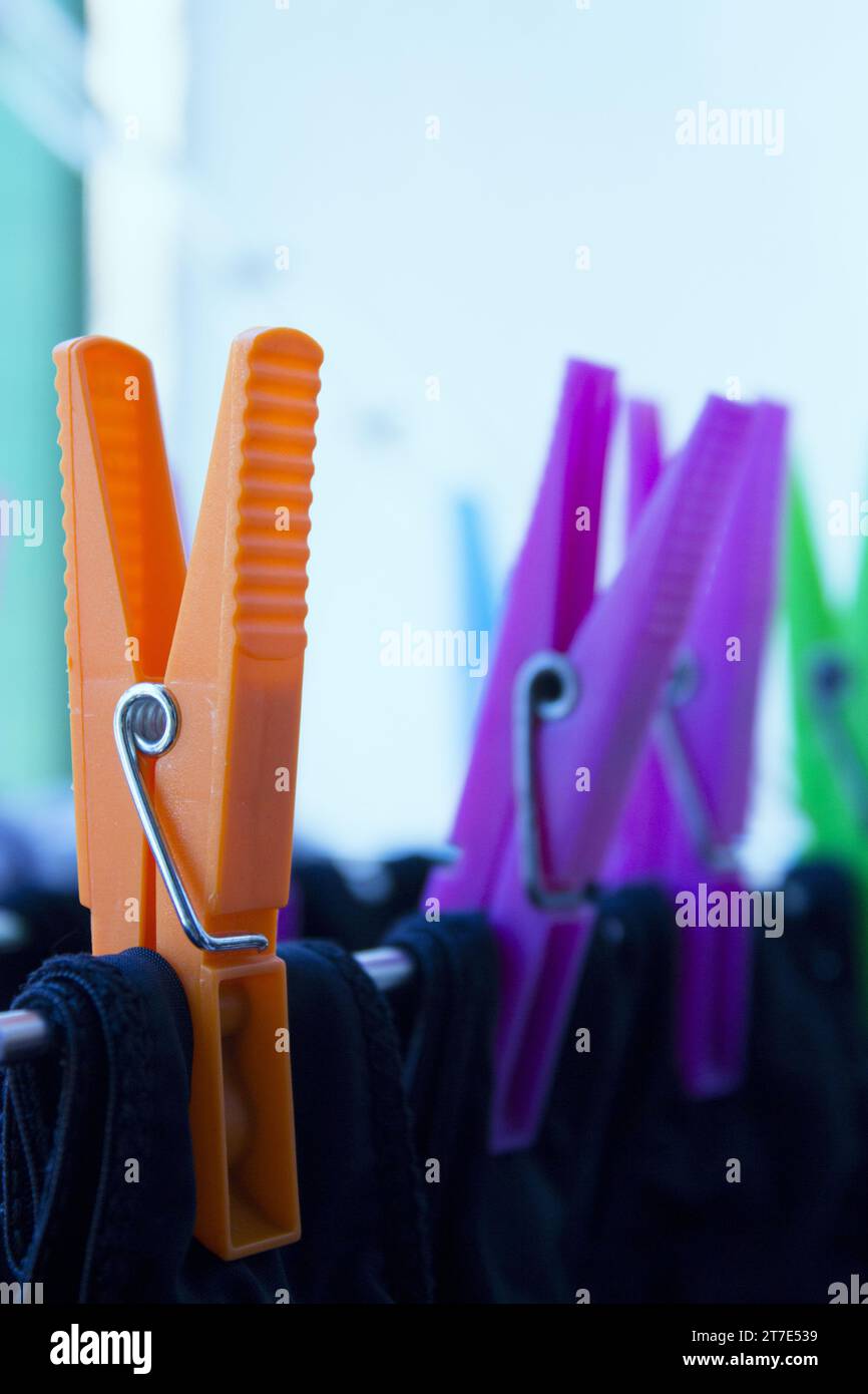 Clothespins holding clothes on clothesline. Various colors. No people ...