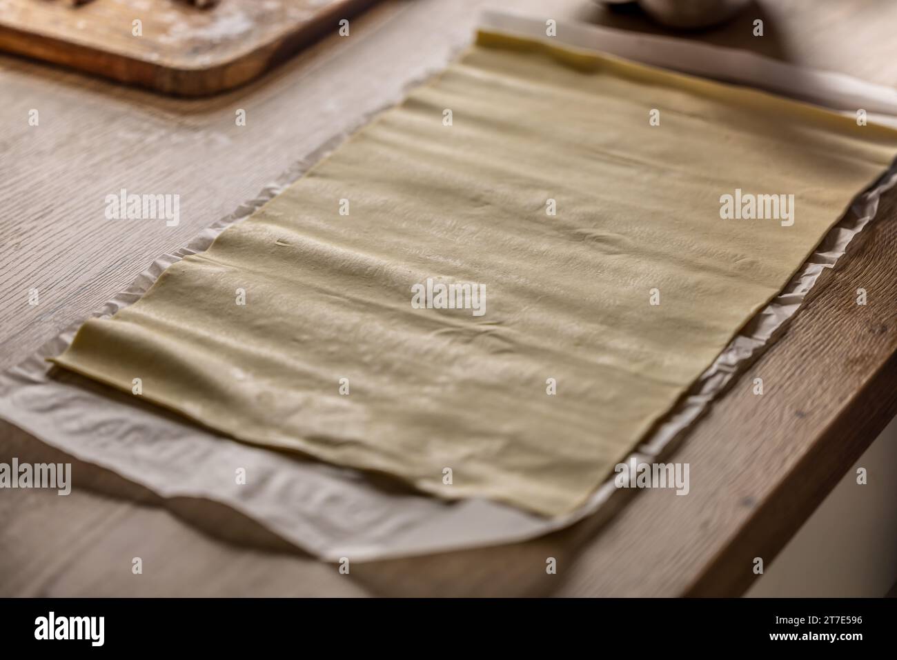 Puff pastry rolled out on baking paper ready for processing Stock Photo ...