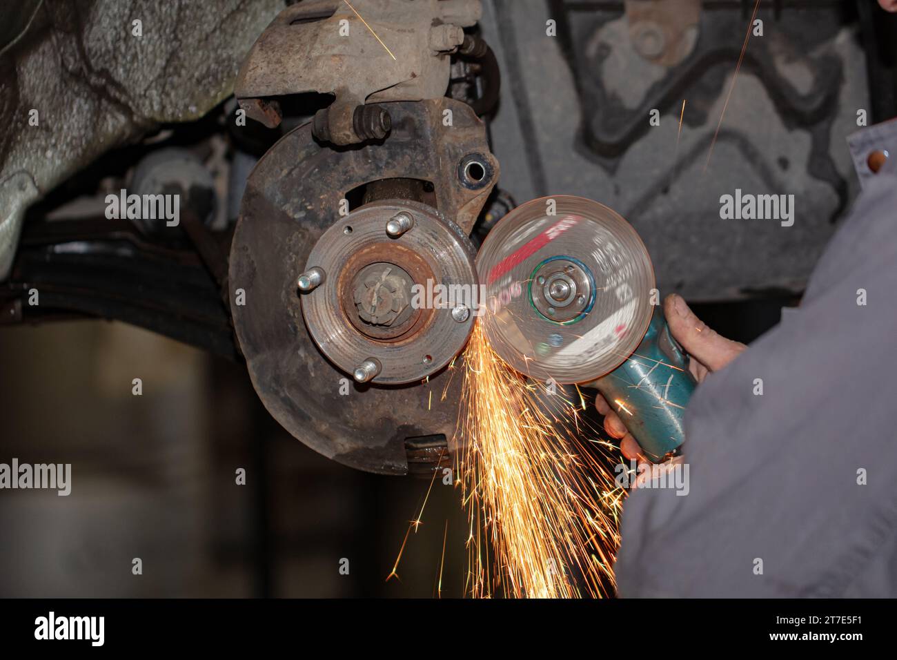 automobile wheel repair using angle grinder in car service Stock Photo ...
