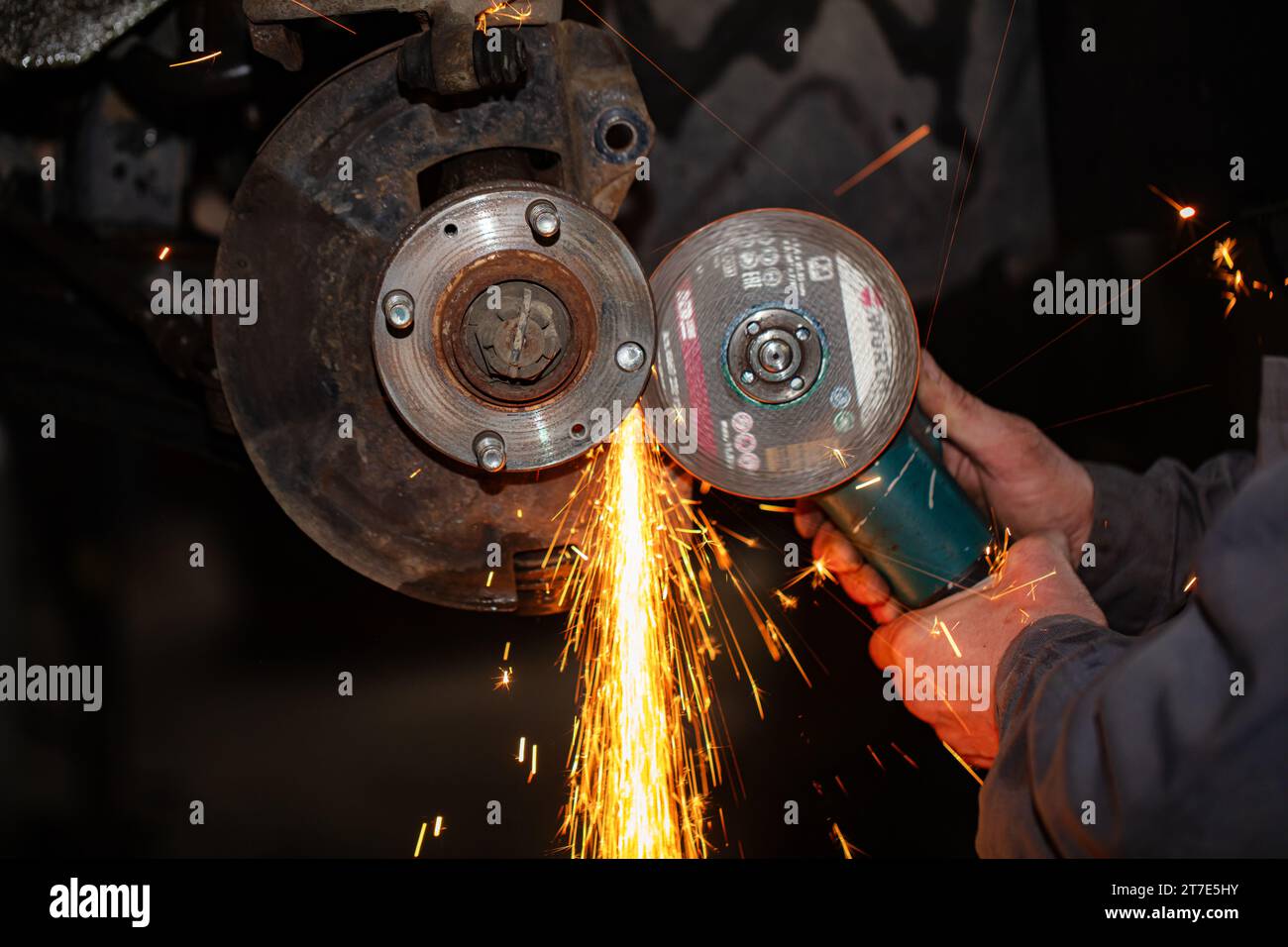 automobile wheel repair using angle grinder in car service Stock Photo ...