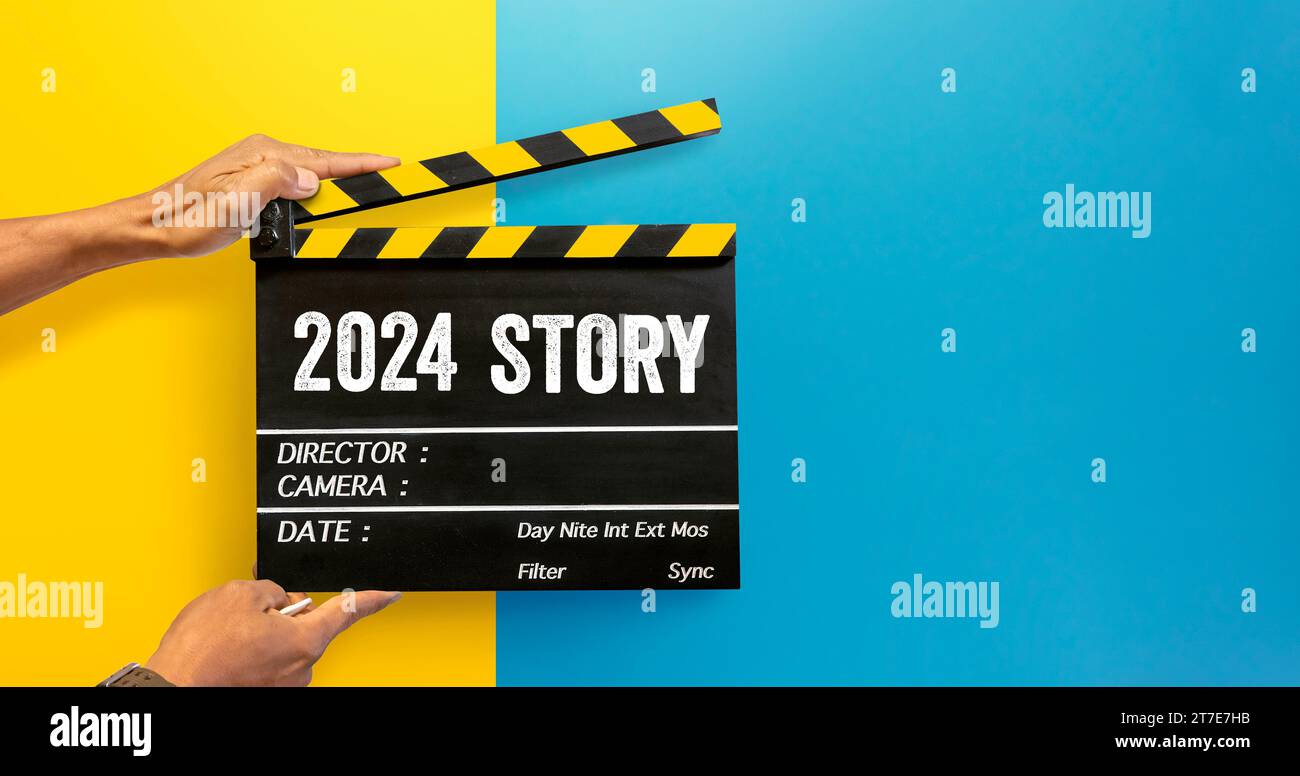 A new story begins in year 2024.Film industry worker holding film slate ...