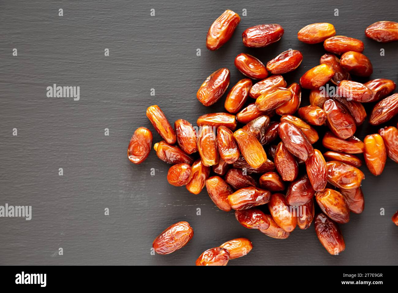 Organic Dry Deglet Nour Dates on a black background. Copy space Stock ...