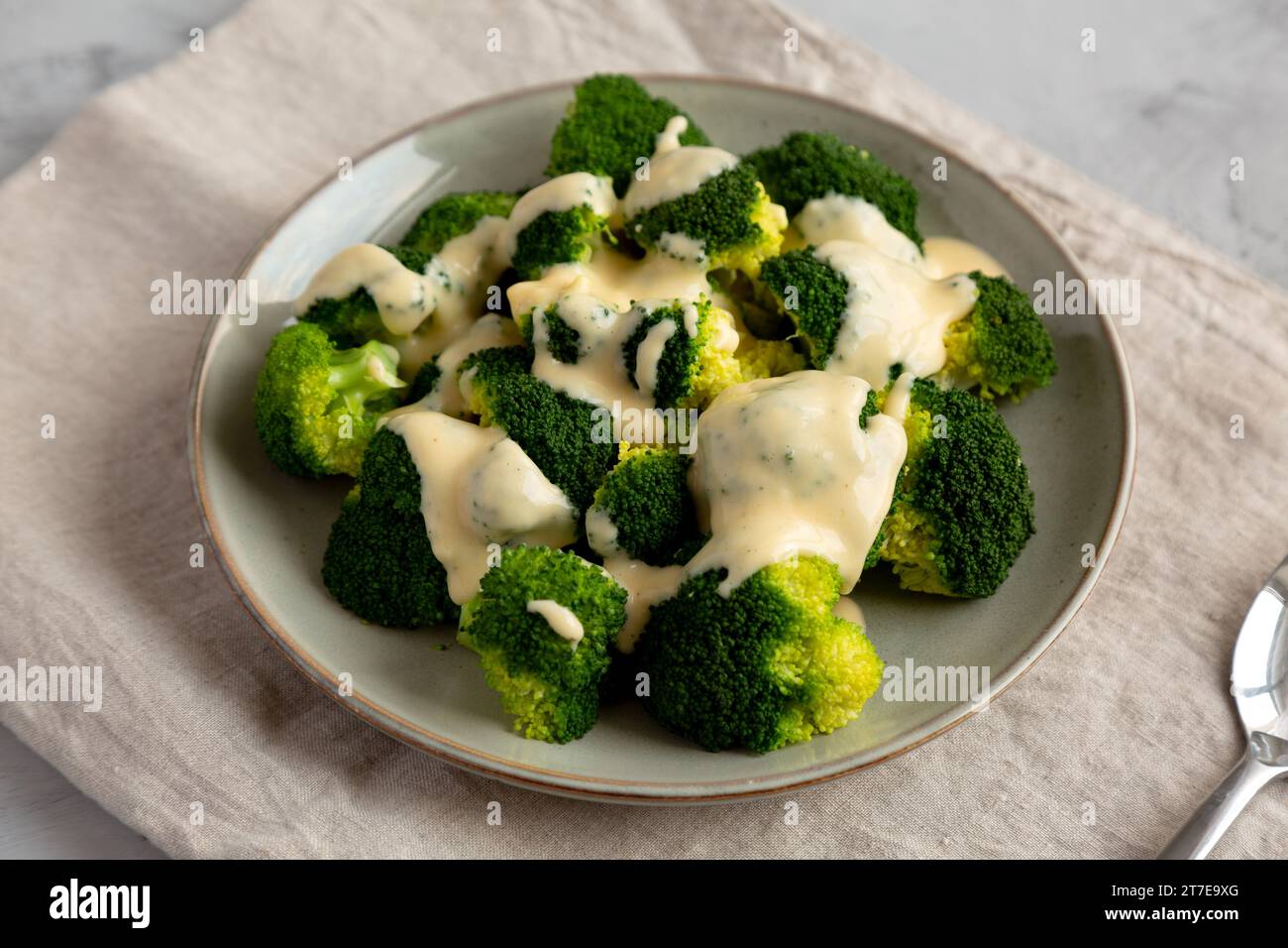 Yummy Cheesy Steamed Broccoli on a Plate, side view Stock Photo - Alamy