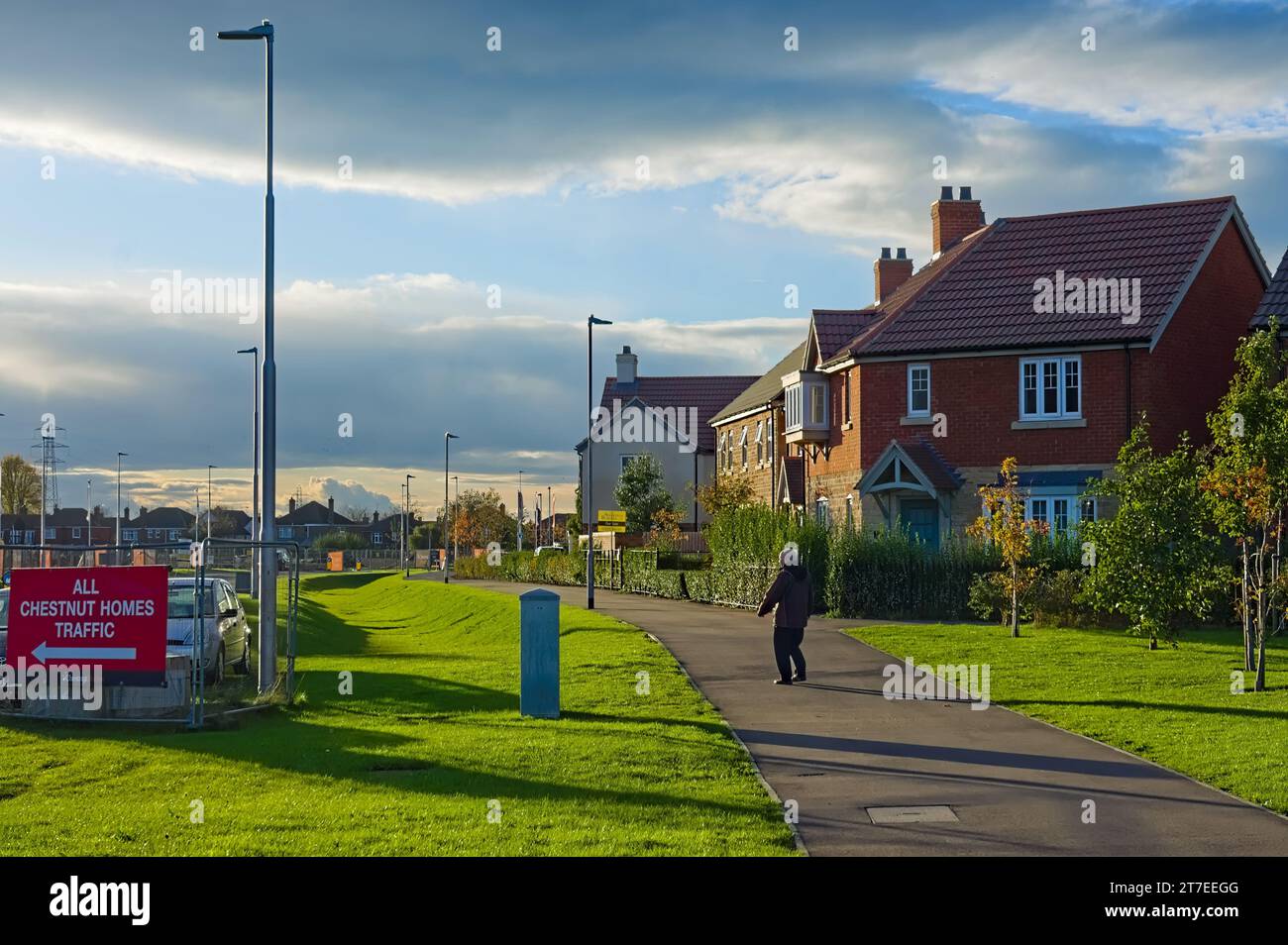 Man walking along a path down the Wyberton quadrant during autumn Stock ...