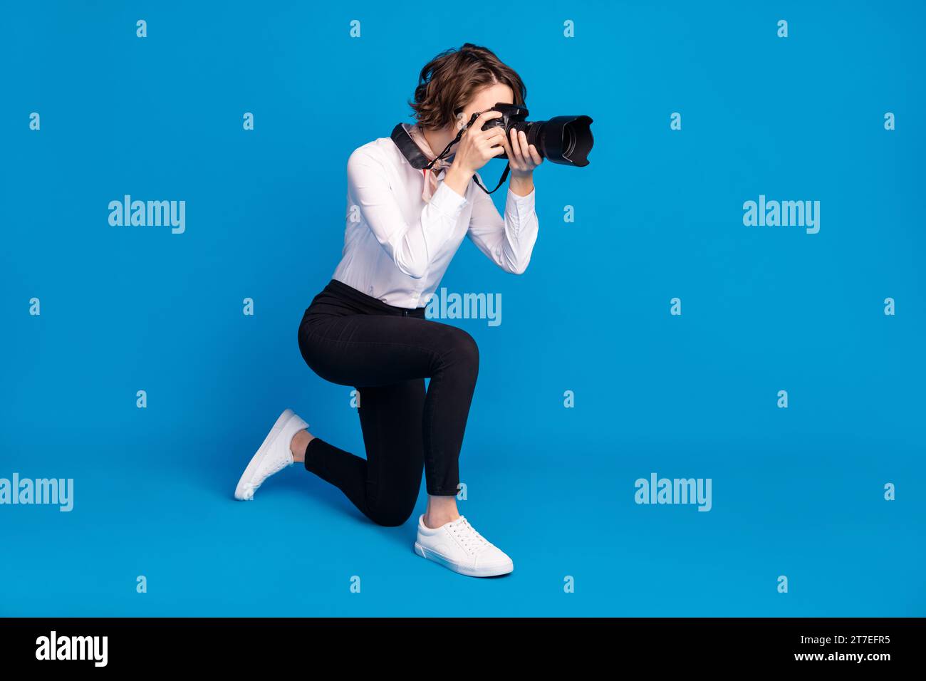 Full size profile portrait of paparazzi stand on knee making photos ...