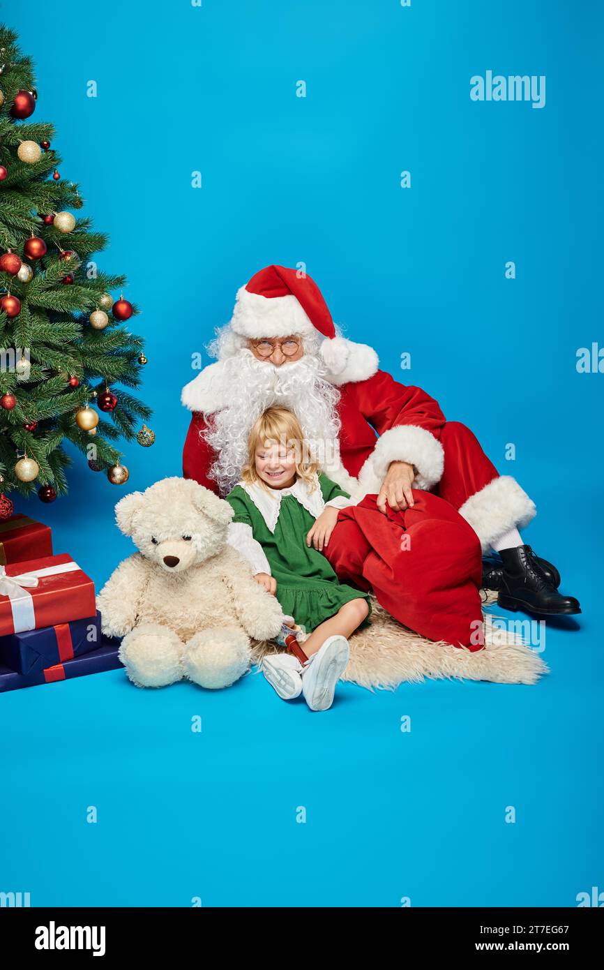 happy girl with prosthetic leg and teddy bear and sitting with Santa ...