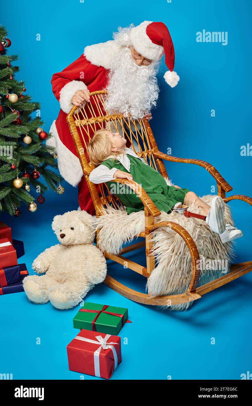 Santa Claus rocking chair with cute girl with prosthetic leg next to ...