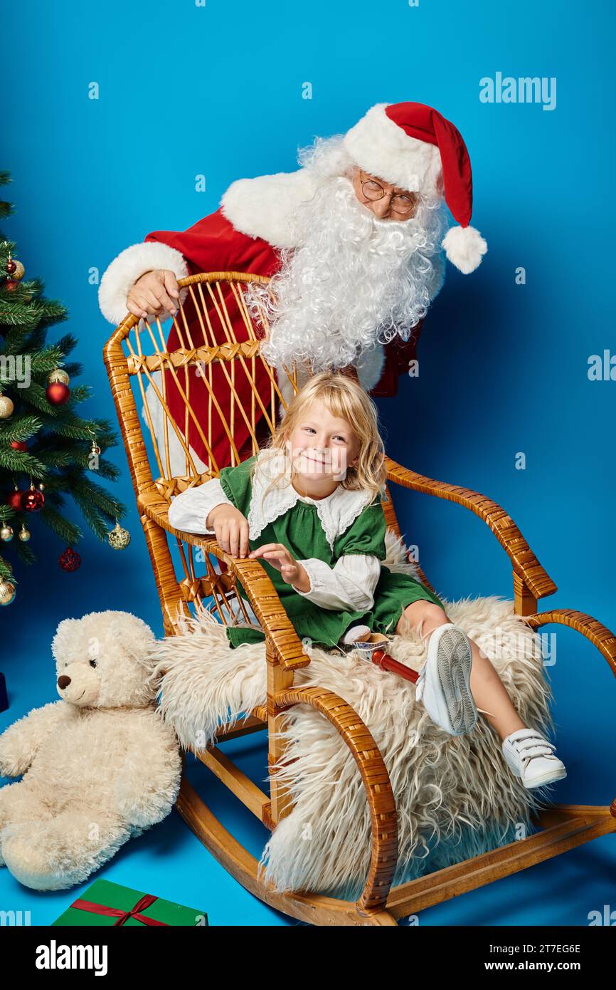 Santa Claus rocking chair with happy girl with prosthetic leg next to ...