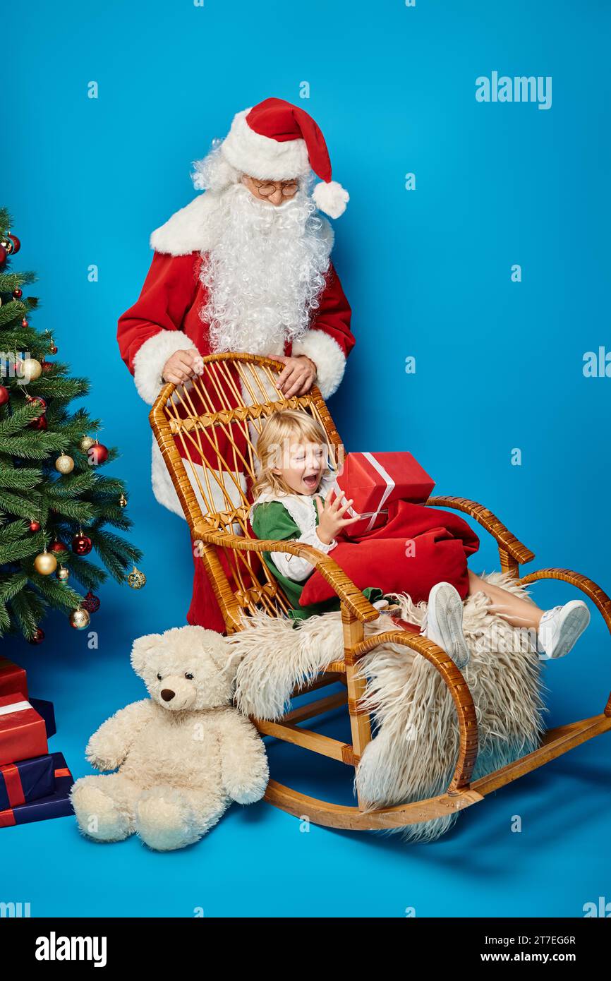 Santa Claus rocking chair with excited girl with prosthetic leg near ...