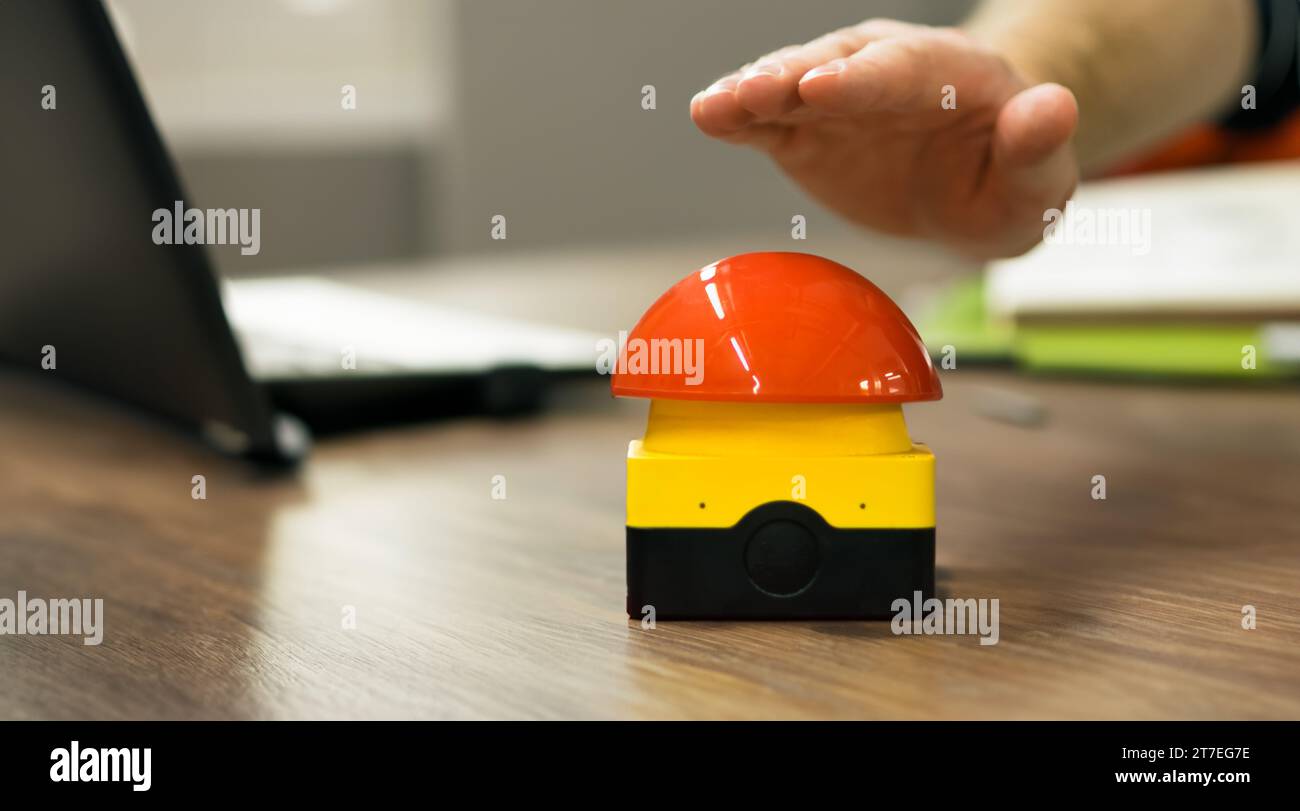 Hand reaches out to hit a buzzer in a office Stock Photo - Alamy