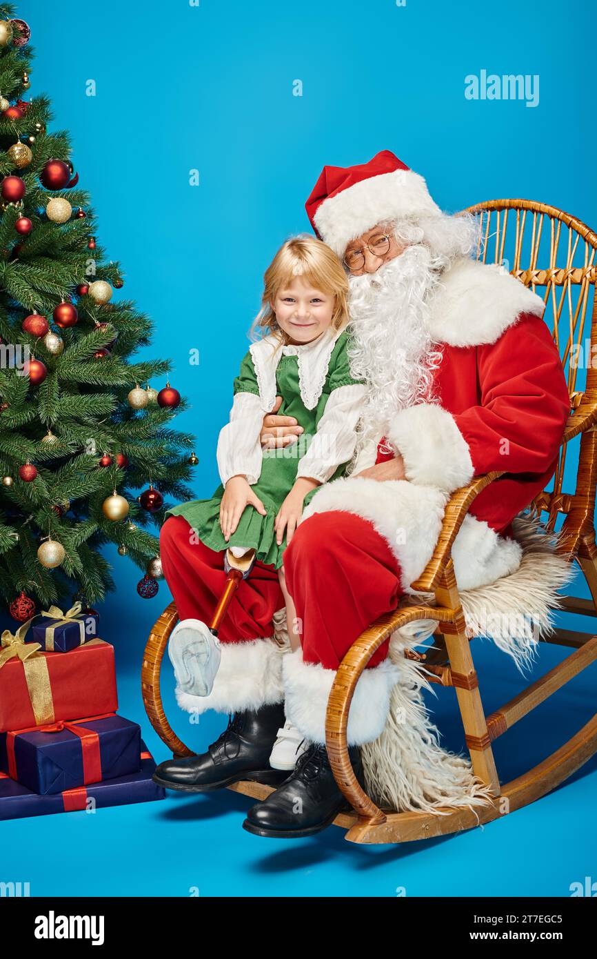 happy girl with prosthetic leg sitting on laps of Santa Claus next to ...