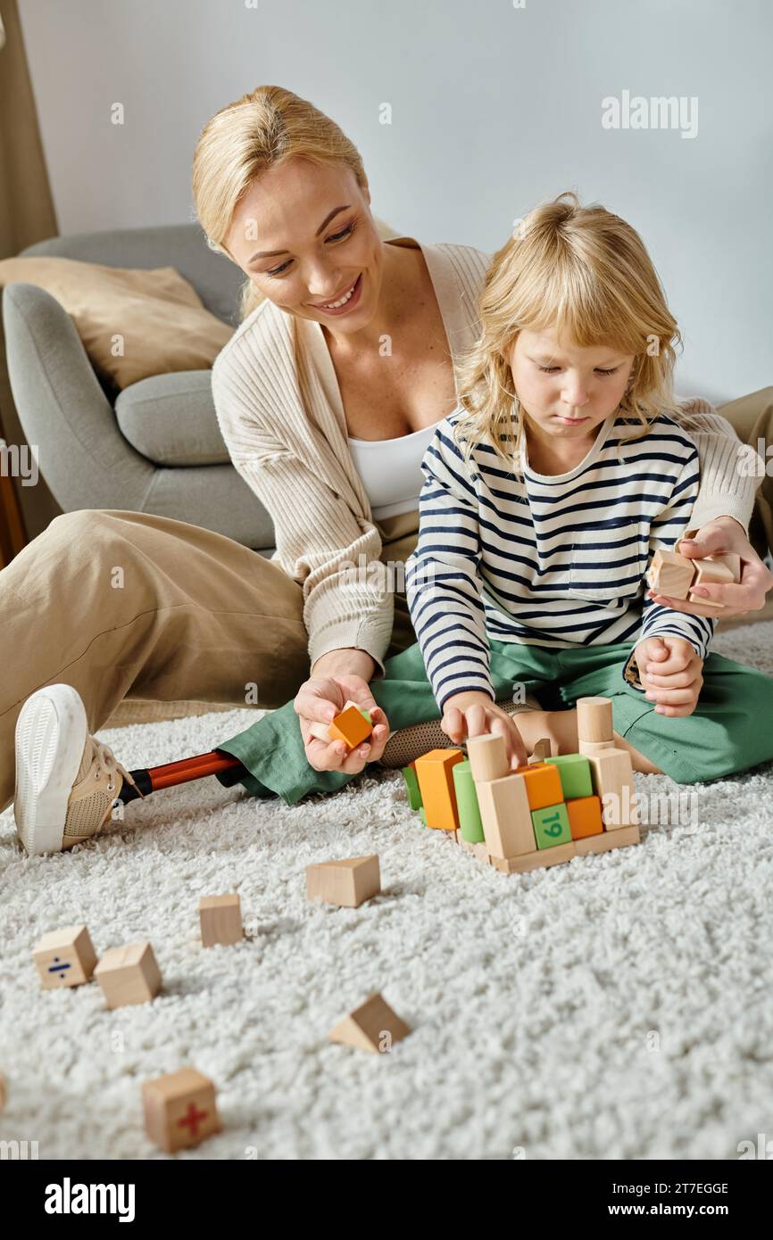 girl with prosthetic leg sitting on carpet and playing with wooden ...