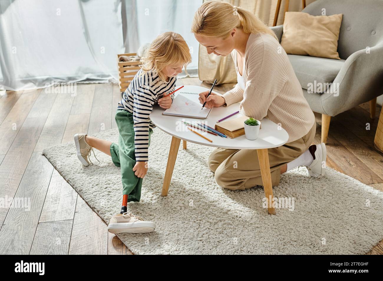 mother and daughter with prosthetic leg drawing on paper with colorful ...