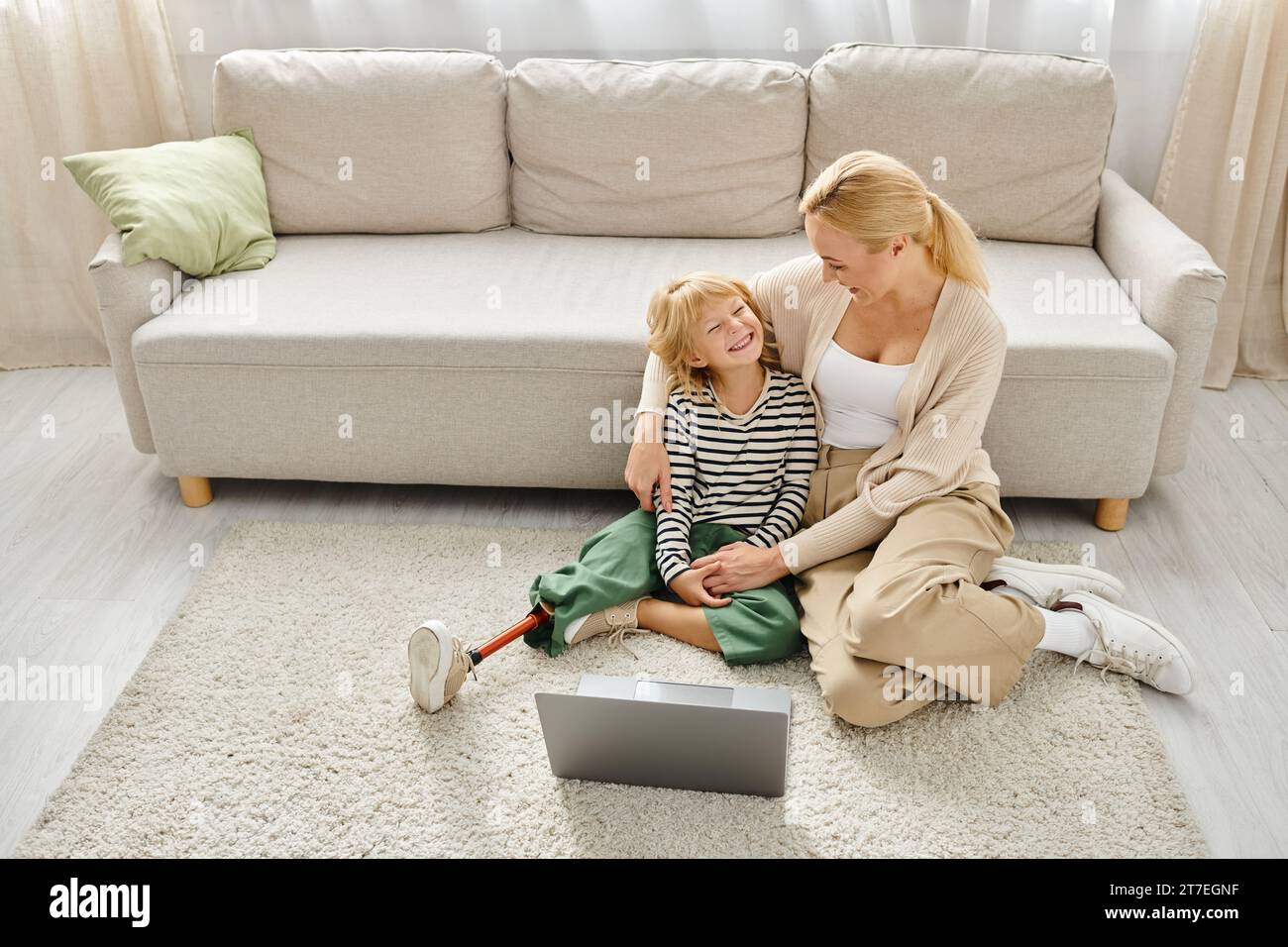 happy girl with prosthetic leg watching movie on laptop and sitting on ...