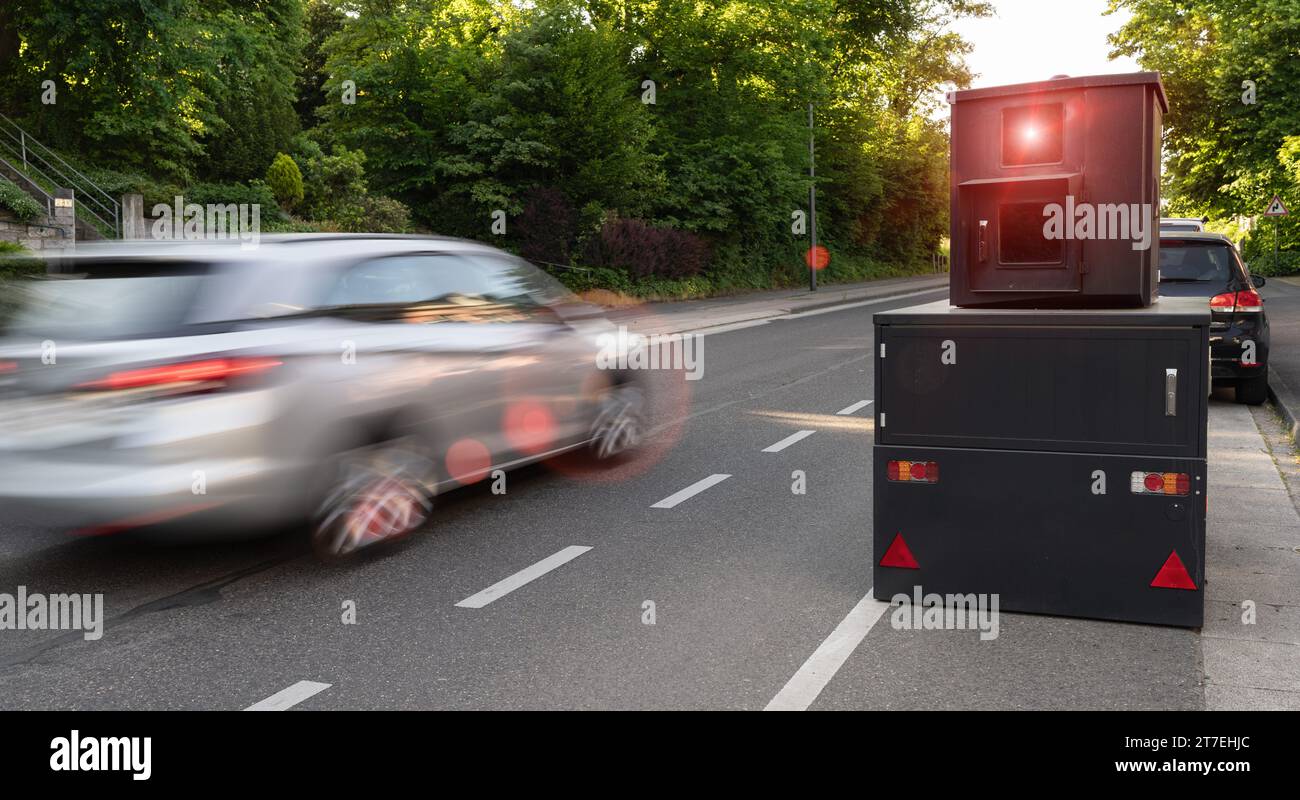 Mobile speed camera on city road with passing cars in motion blur ...