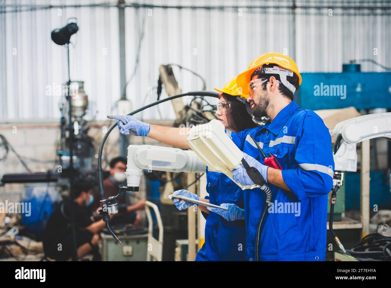 Engineers team mechanic using computer controller Robotic arm for ...