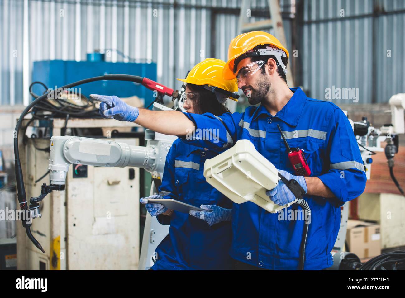 Engineers team mechanic using computer controller Robotic arm for ...