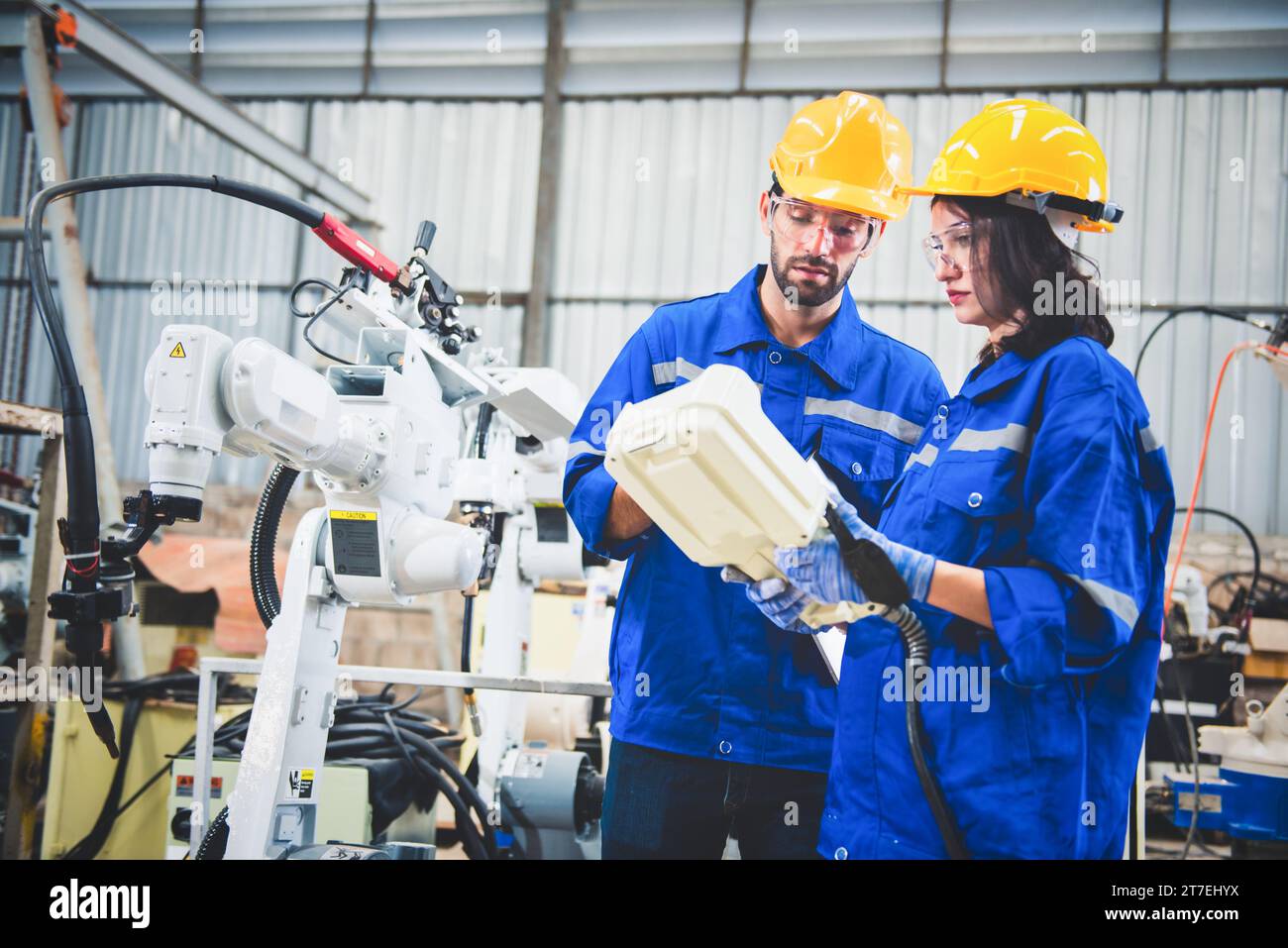 Engineers team mechanic using computer controller Robotic arm for ...