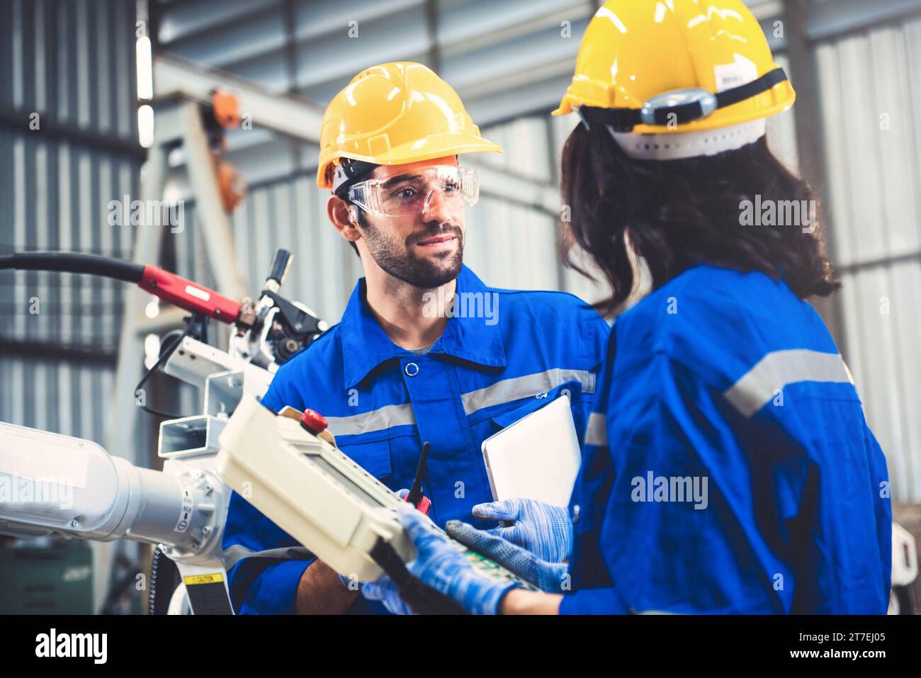 Engineers team mechanic using computer controller Robotic arm for ...