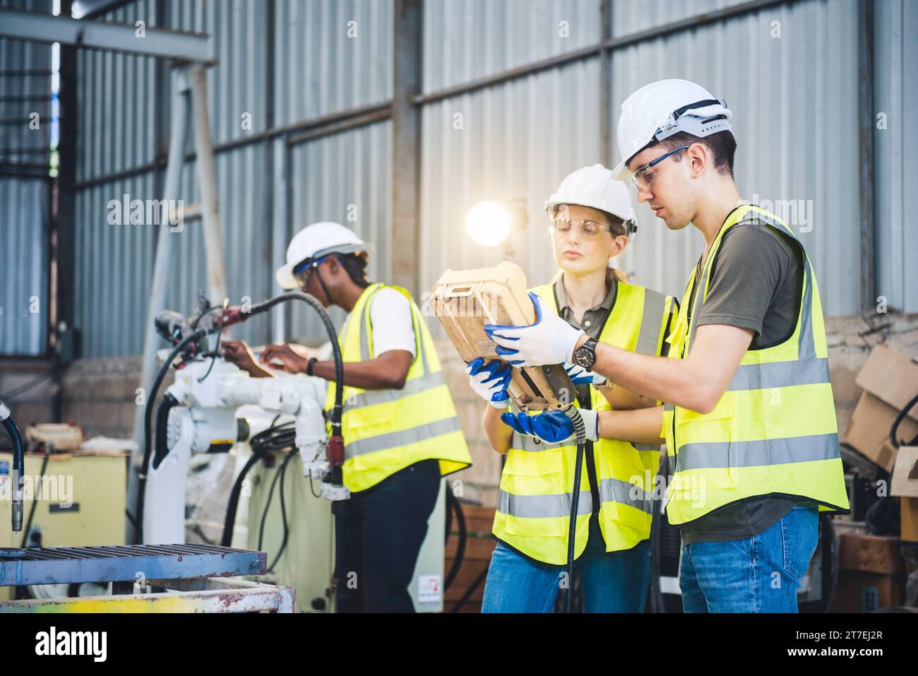 Engineers team mechanic using computer controller Robotic arm for ...