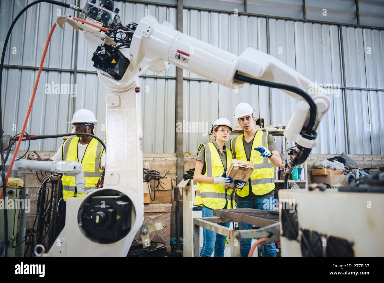 Engineers team mechanic using computer controller Robotic arm for ...