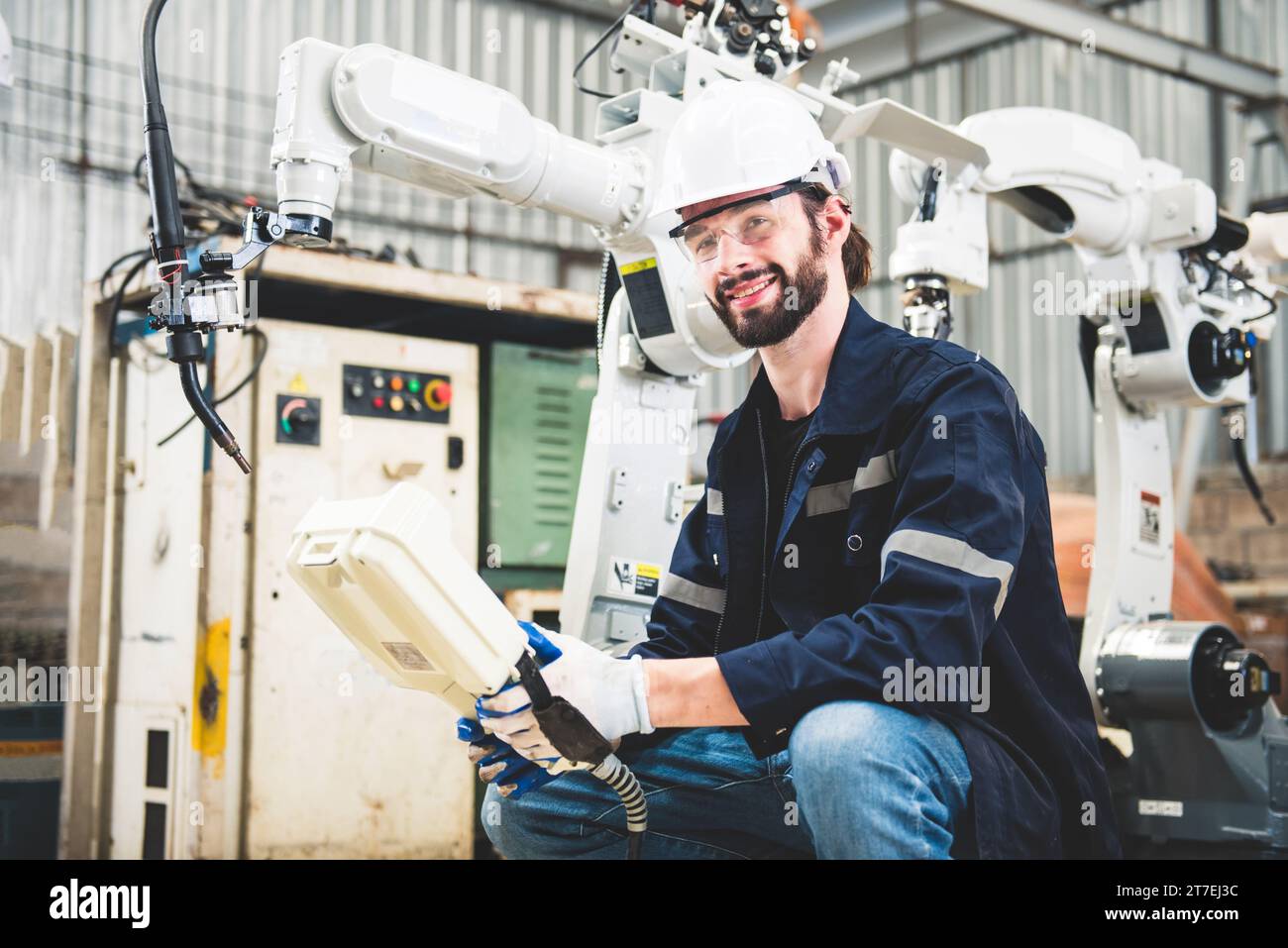 Engineers team mechanic using computer controller Robotic arm for ...